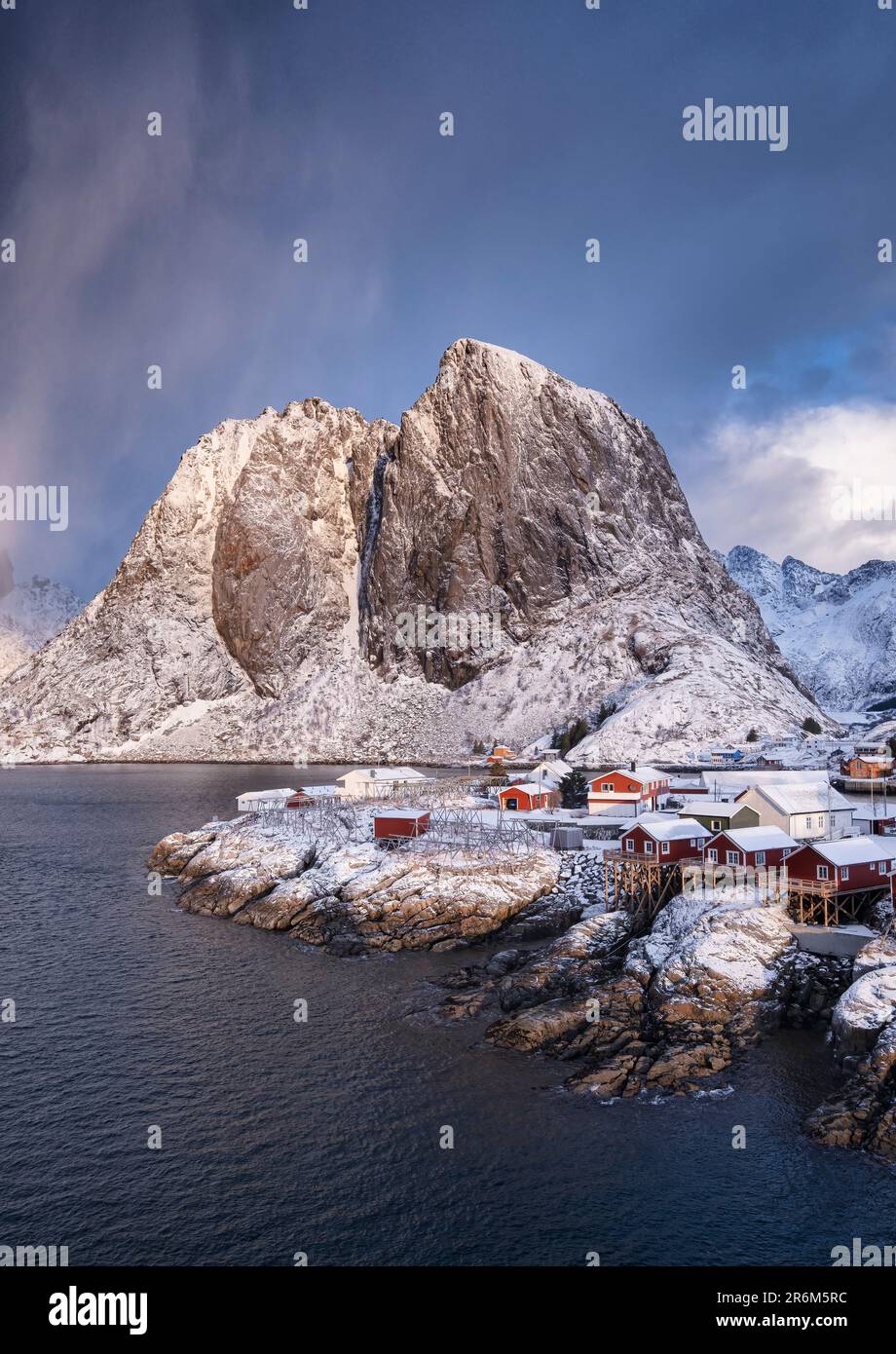 Red Norwegian Rorbuer Huts and Festhaeltinden mountain in winter ...