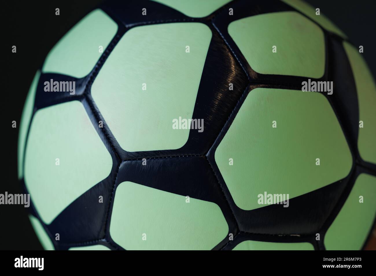 green black ball for handball in the athlete's hand on a black ...