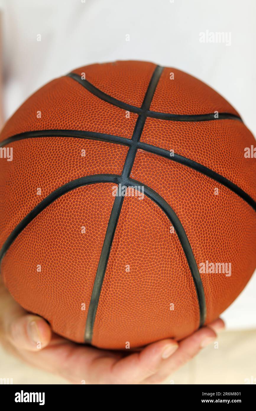 Red basketball in the hands of a close-up on a white background Stock ...