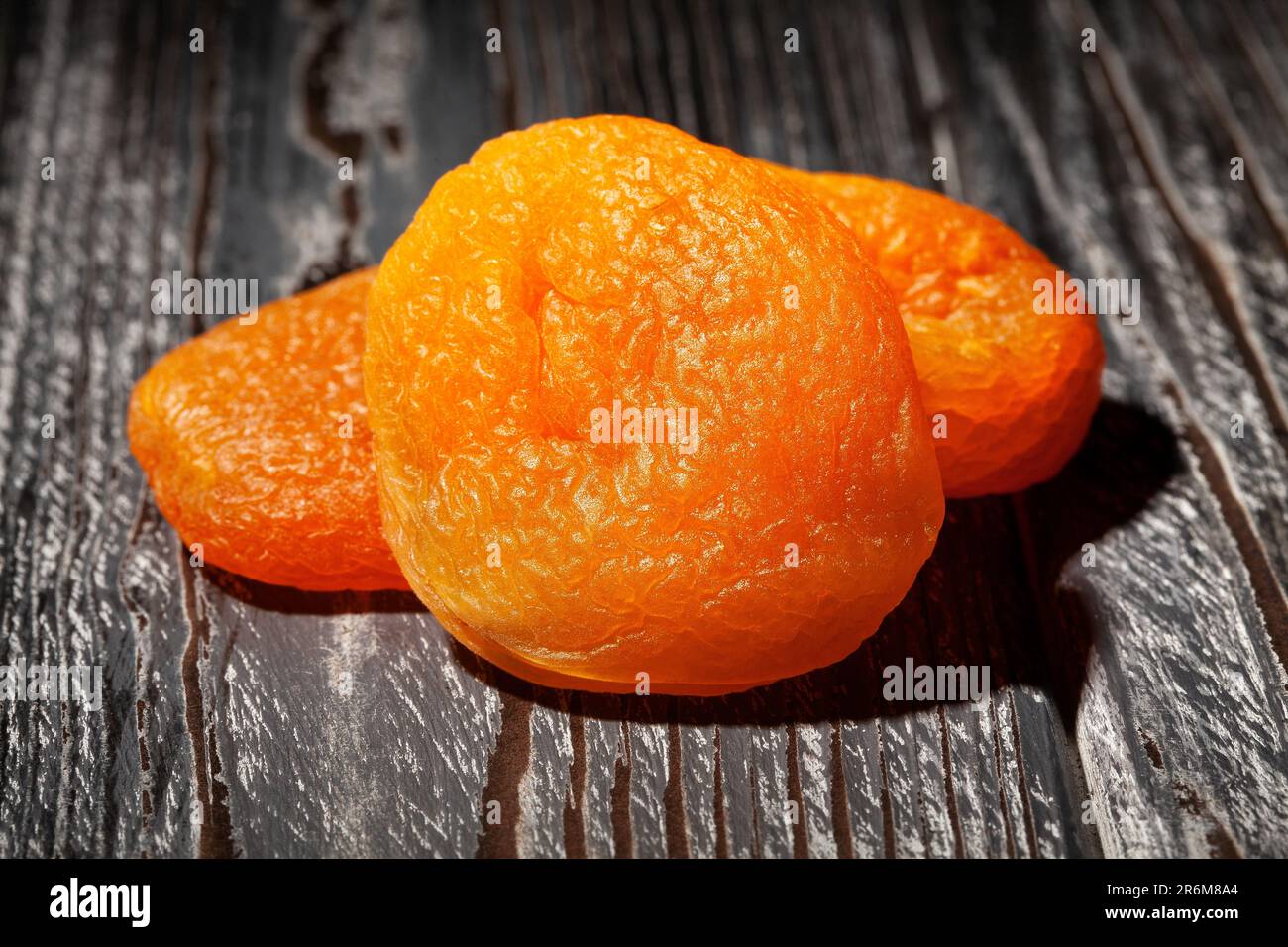 dried apricot on wood background Stock Photo - Alamy