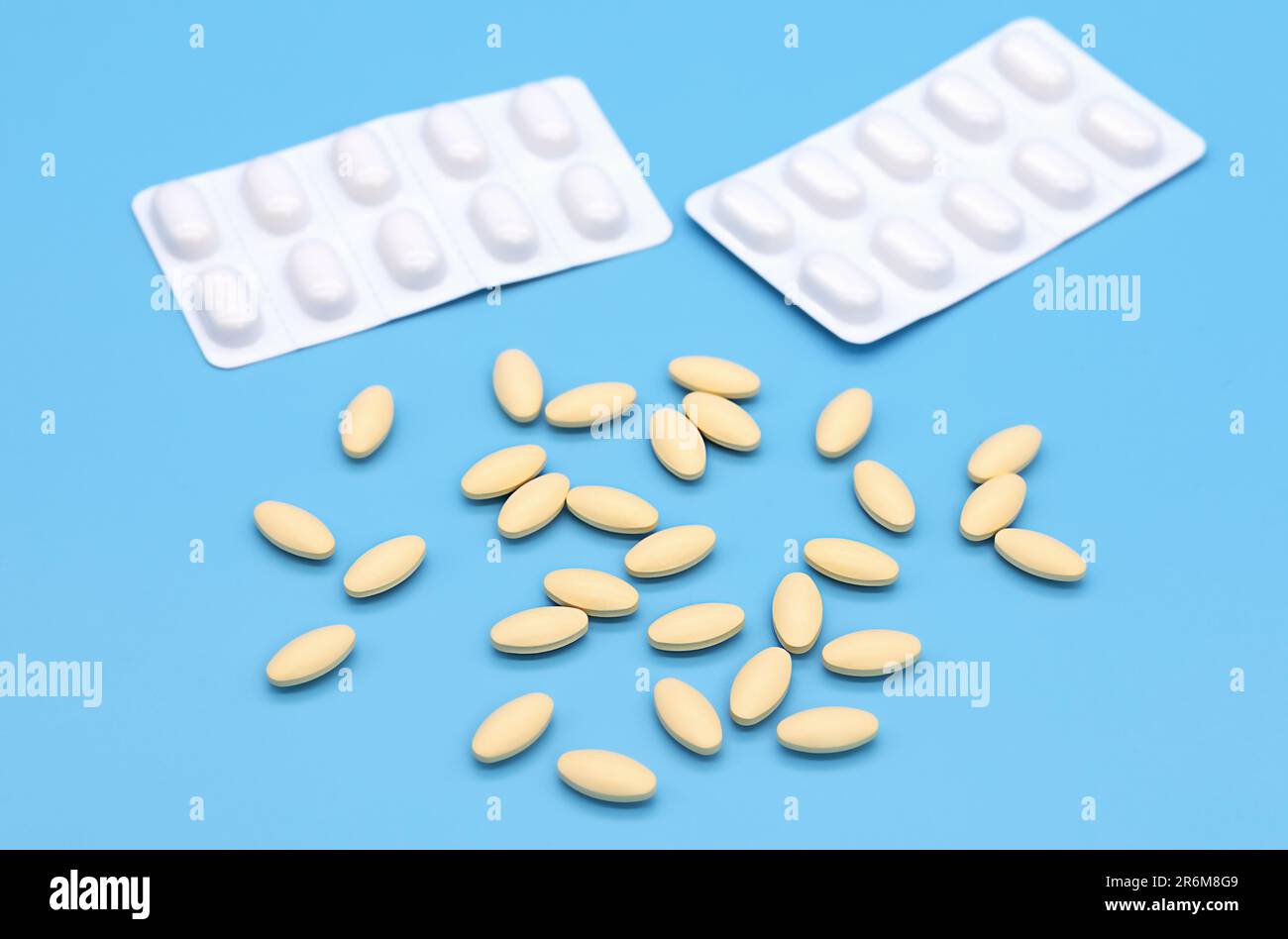 blisters and oval-shaped tablets lie on a contrasting background Stock ...