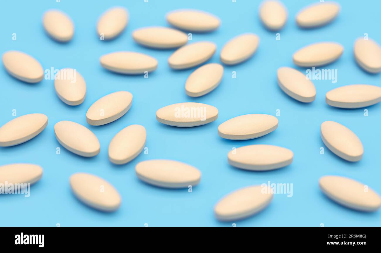 oval-shaped tablets lie on a contrasting background Stock Photo - Alamy