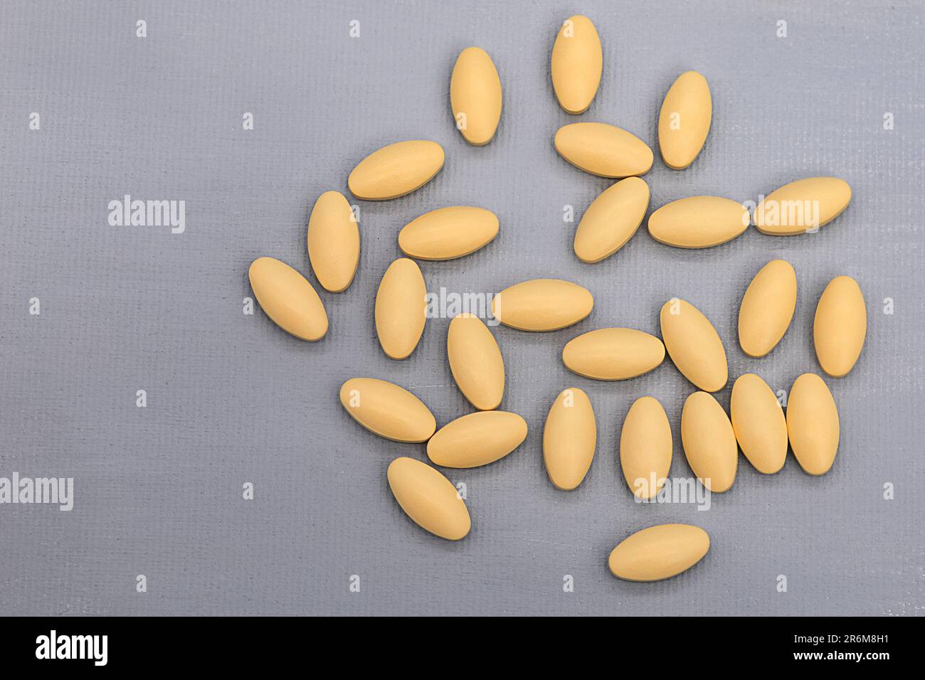 oval-shaped tablets lie on a contrasting background Stock Photo - Alamy