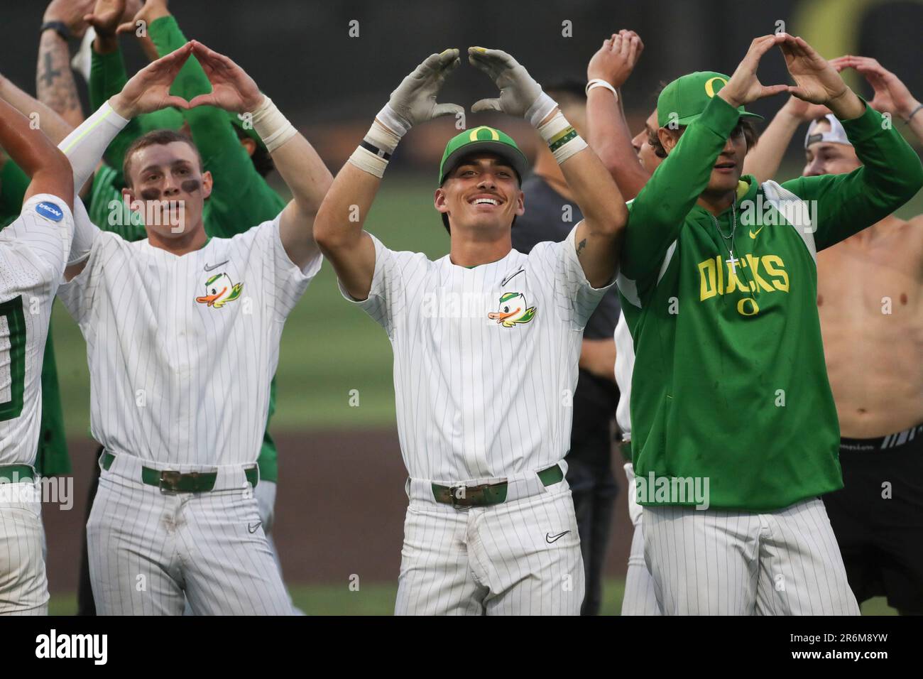 Oregon players celebrate their 9-8 win over Oral Roberts during an NCAA ...