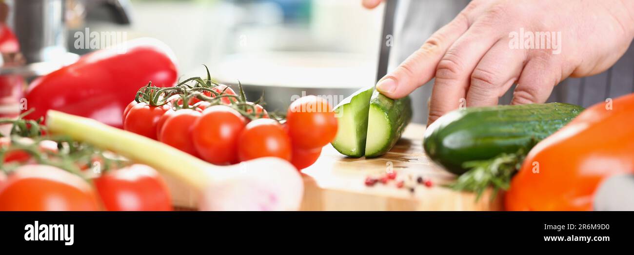 Male chef preparing healthy vegetable salad with fresh organic ...