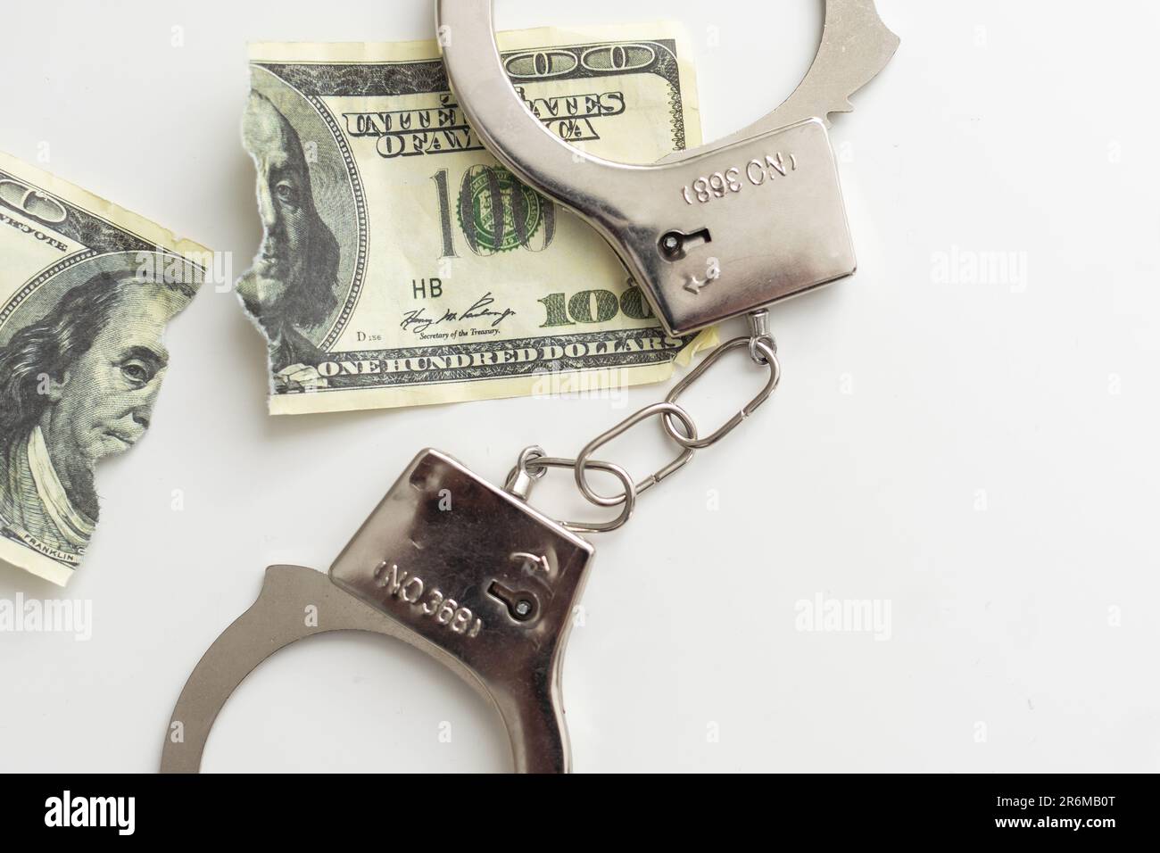 One Hundred Dollar Bill Ripped in Half Isolated on a White Background ...