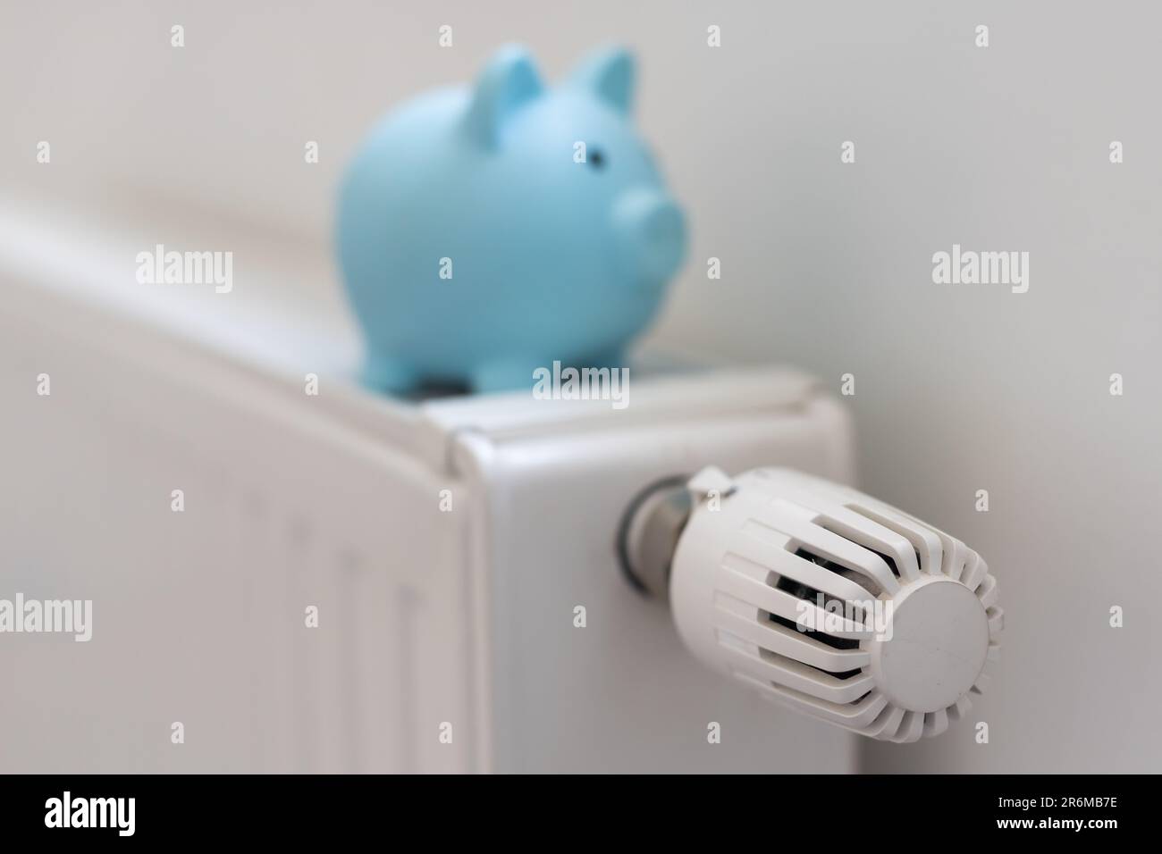 save heating costs, heating radiator with piggy bank, white background ...