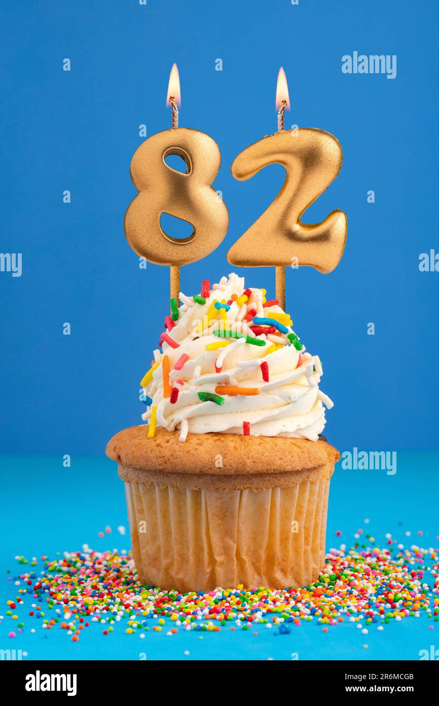 Birthday cake with candle number 82 - Blue background Stock Photo - Alamy