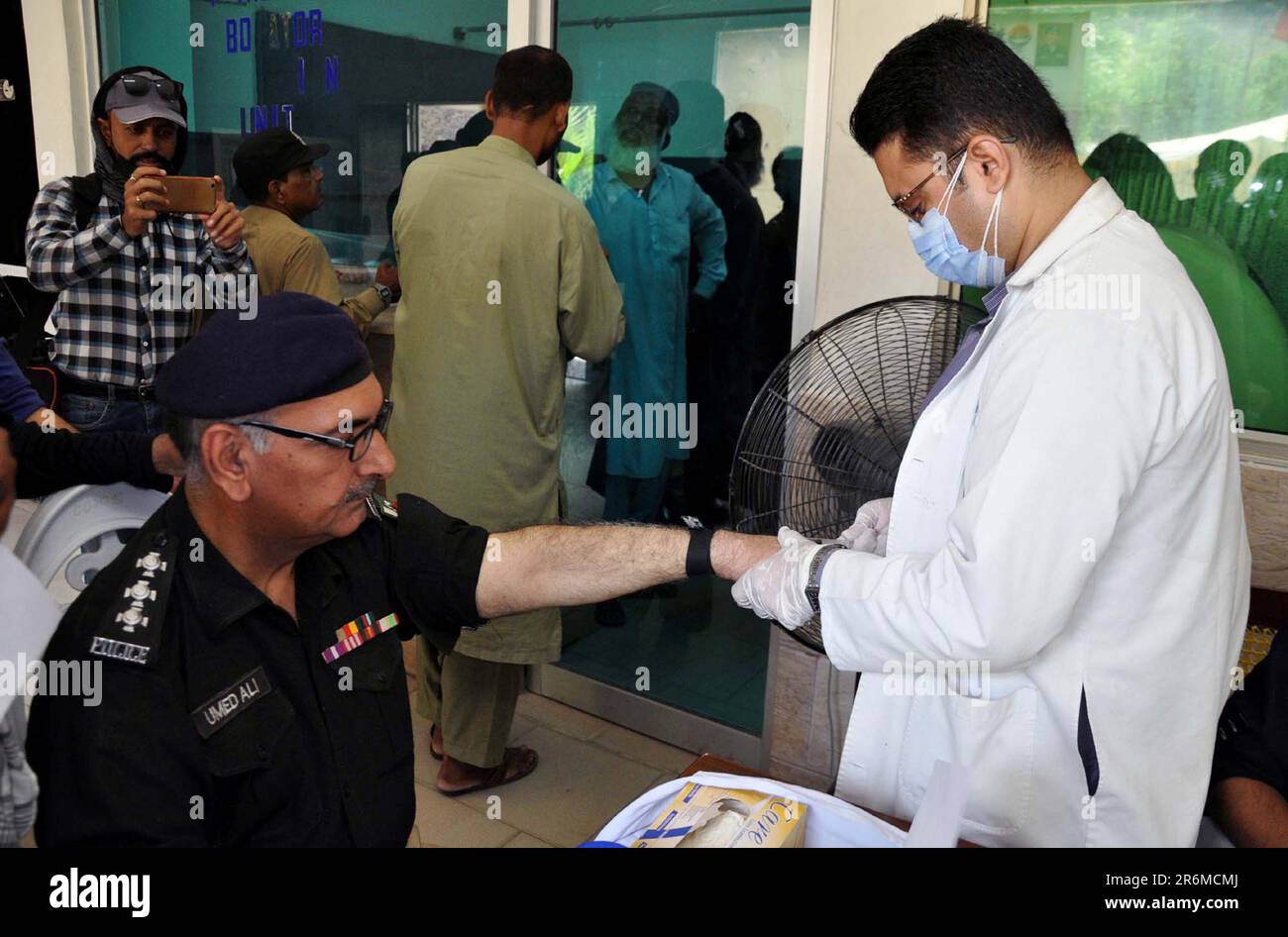 Police officials are being examining by doctors during free medical ...