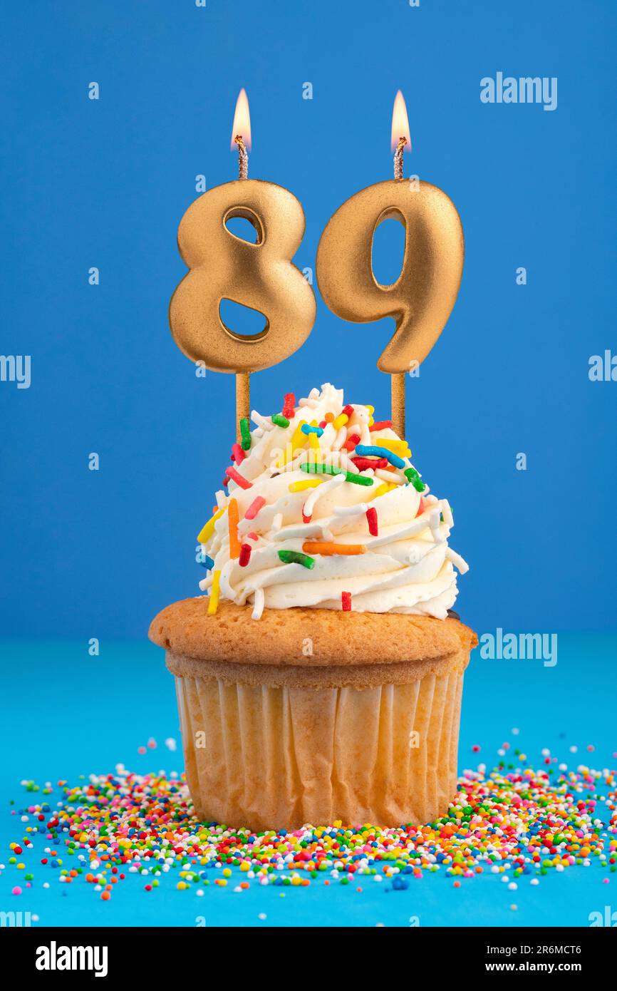 Candle number 89 - Cake birthday in blue background Stock Photo - Alamy