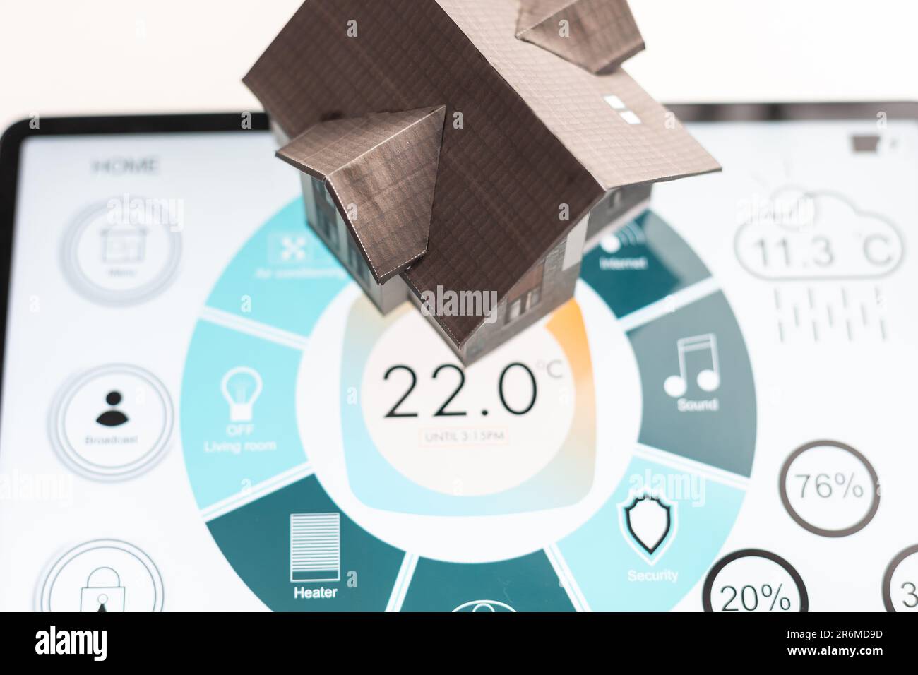 Small house model is on screen tablet and icons home electronics ...
