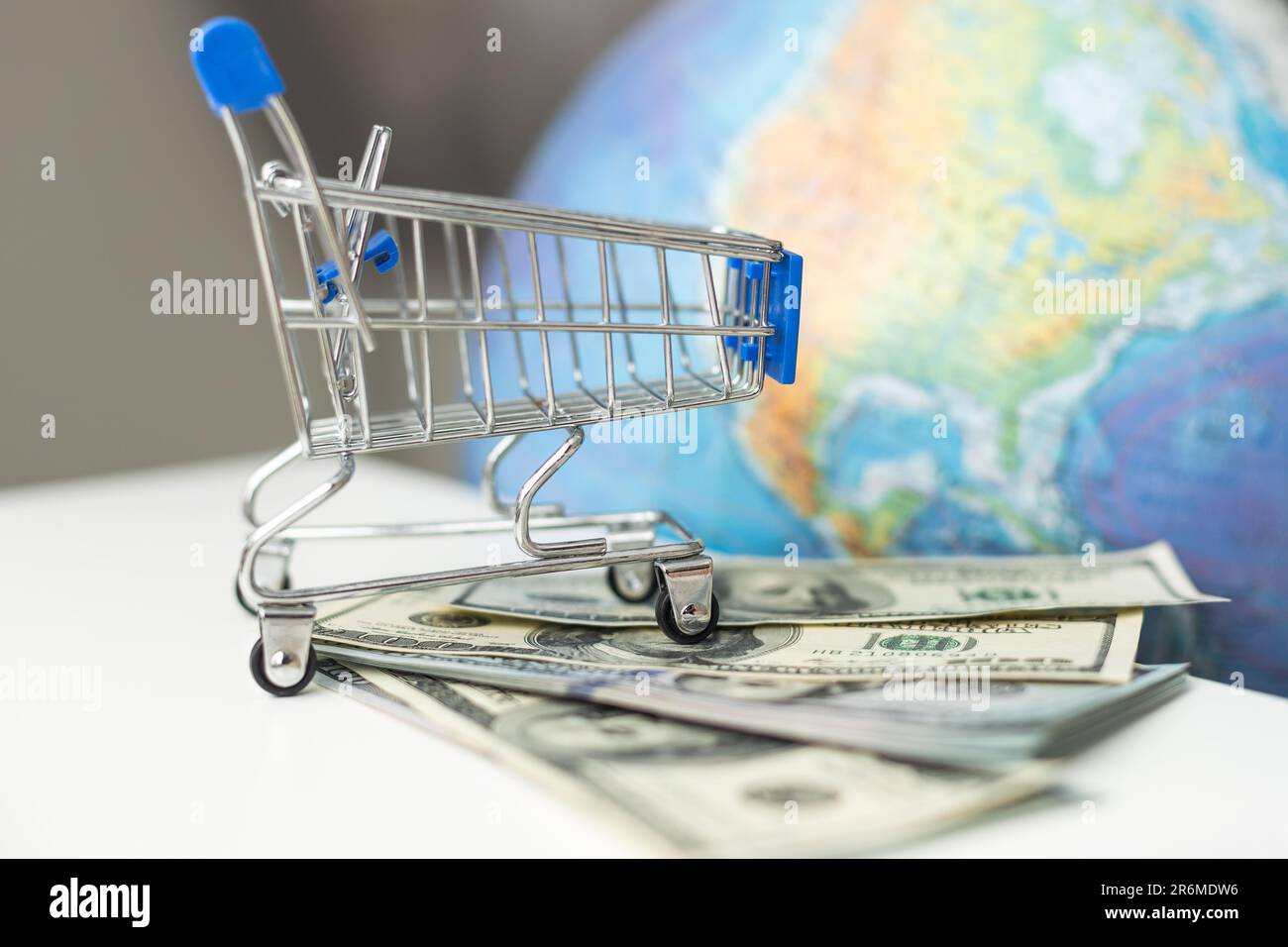 a planet earth in a supermarket shopping cart on blue background. copy ...