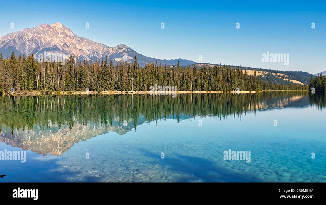 Pyramid Mountain is reflected in the pristine waters of the Pyramid ...