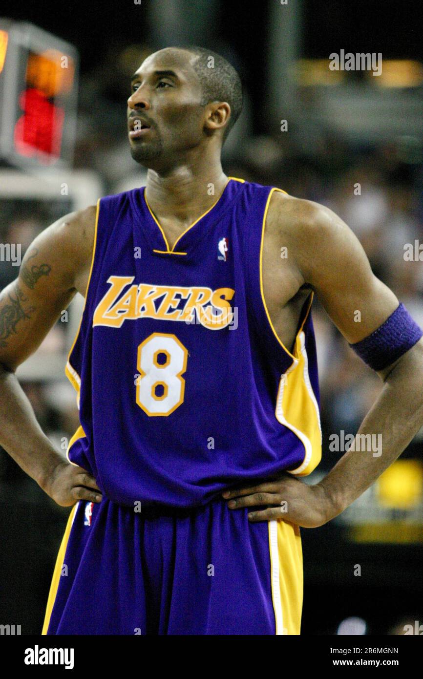 A man in a basketball costume with an 8 number standing confidently in ...