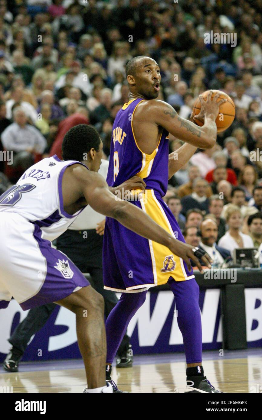 Two professional basketball players in a stadium, surrounded by an ...