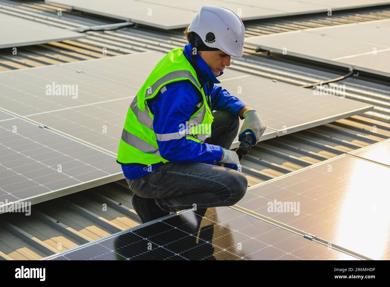 Maintenance technicians installing solar panels at solar cell farm ...