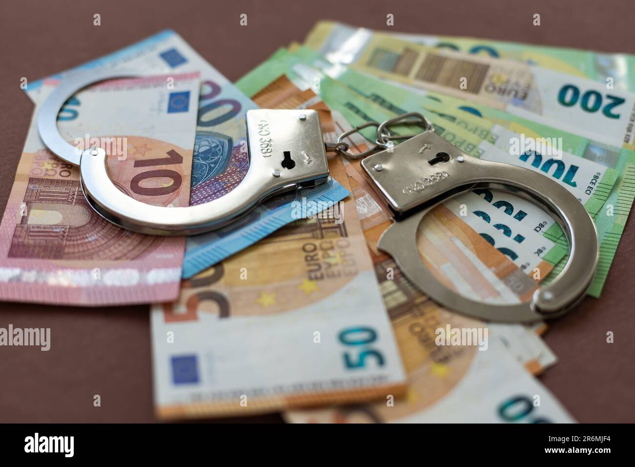 economic crimes.Handcuffs on euro bills background.Arrest on bank ...
