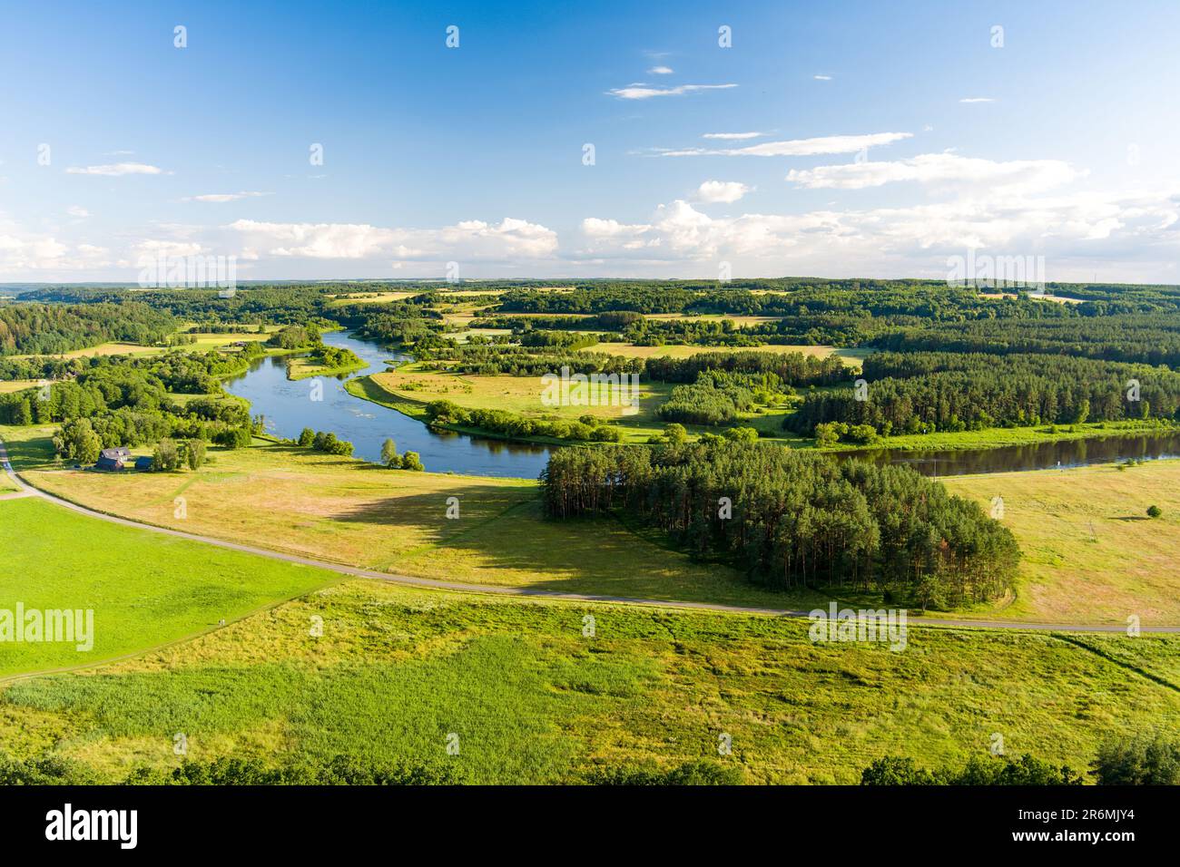 Scenic view of beautiful green Lithuanian countryside with a river in a ...