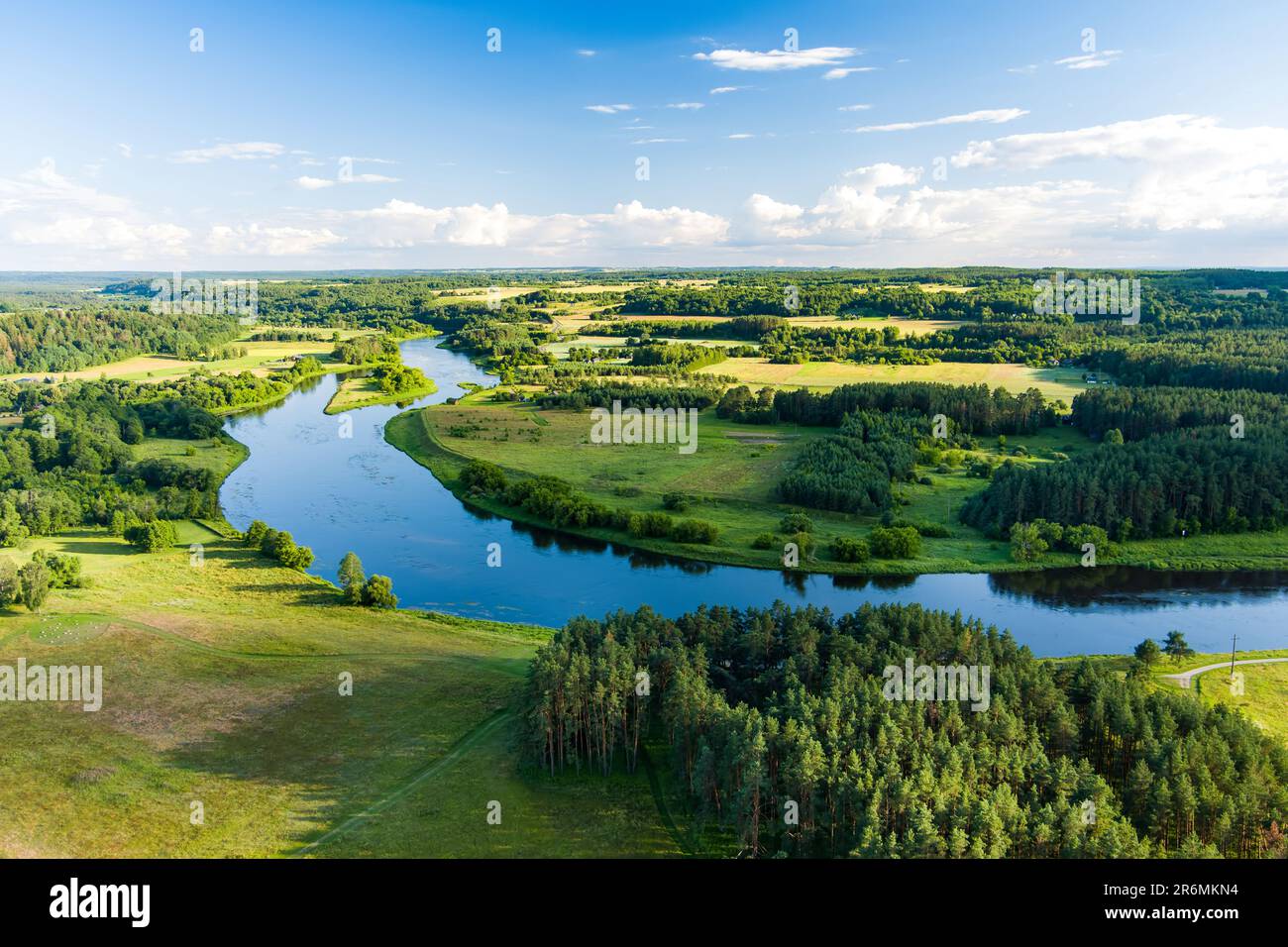 Scenic view of beautiful green Lithuanian countryside with a river in a ...