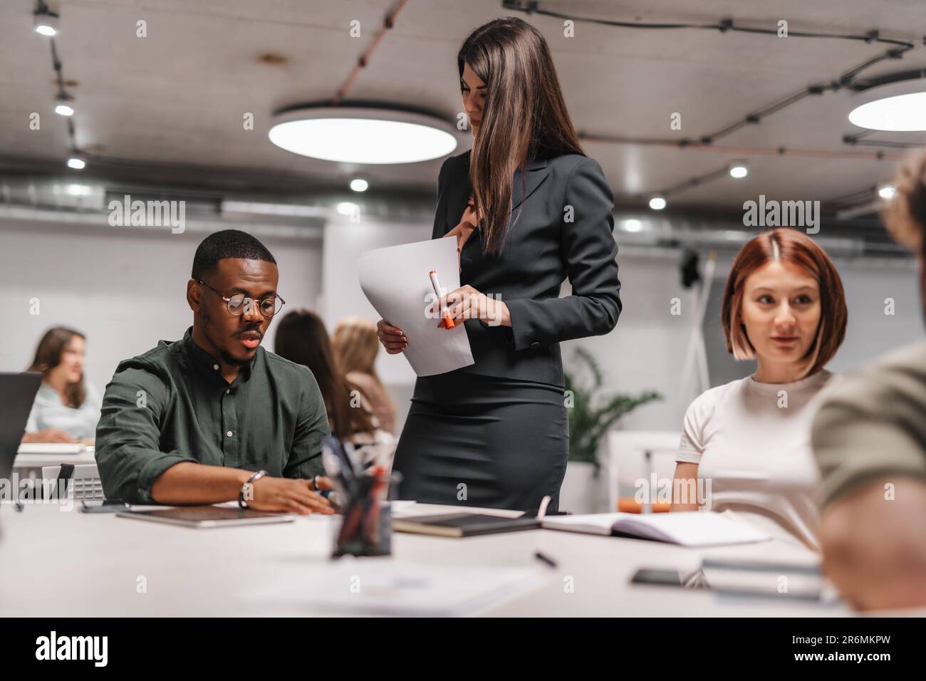 Dissatisfied boss coming to lecture the employees at the office Stock ...