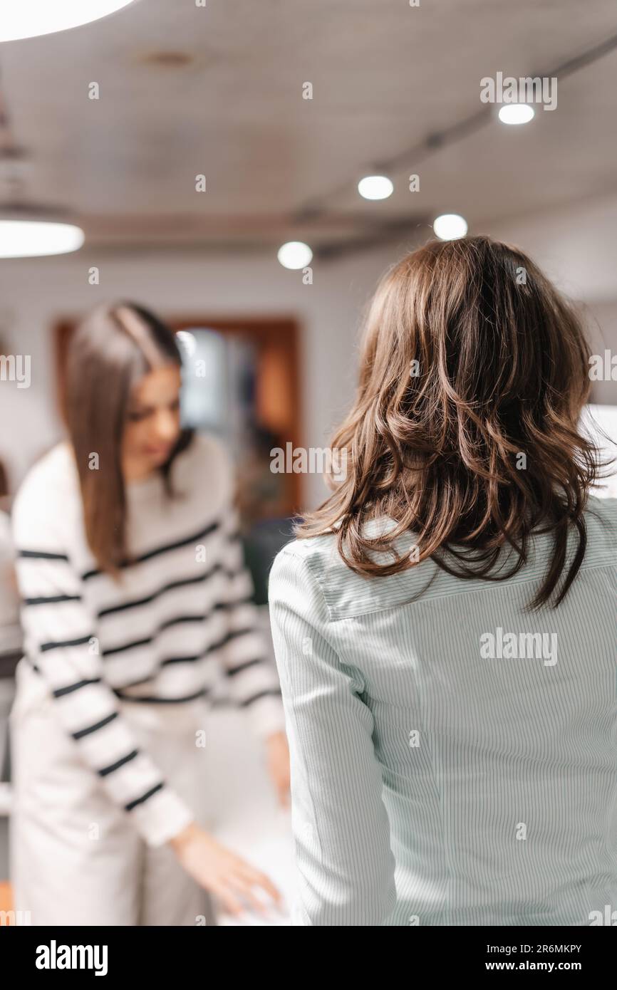 Two young girls working together at the office Stock Photo - Alamy