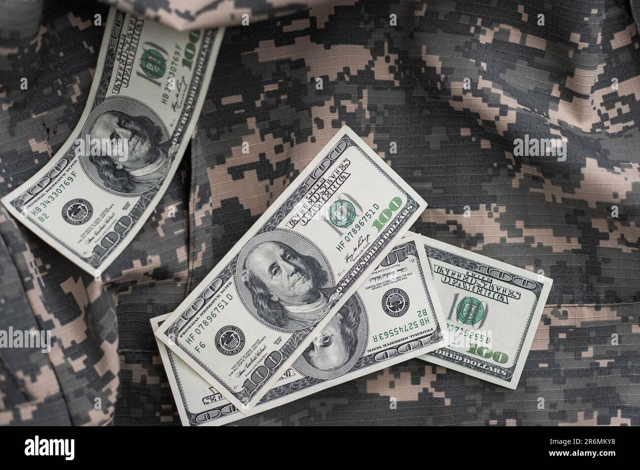 US dollar bills on fabric with texture of Ukrainian military pixeled ...