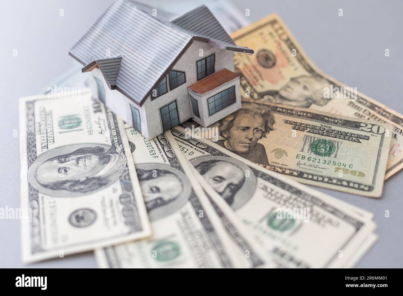 Investment, model house and money Stock Photo - Alamy