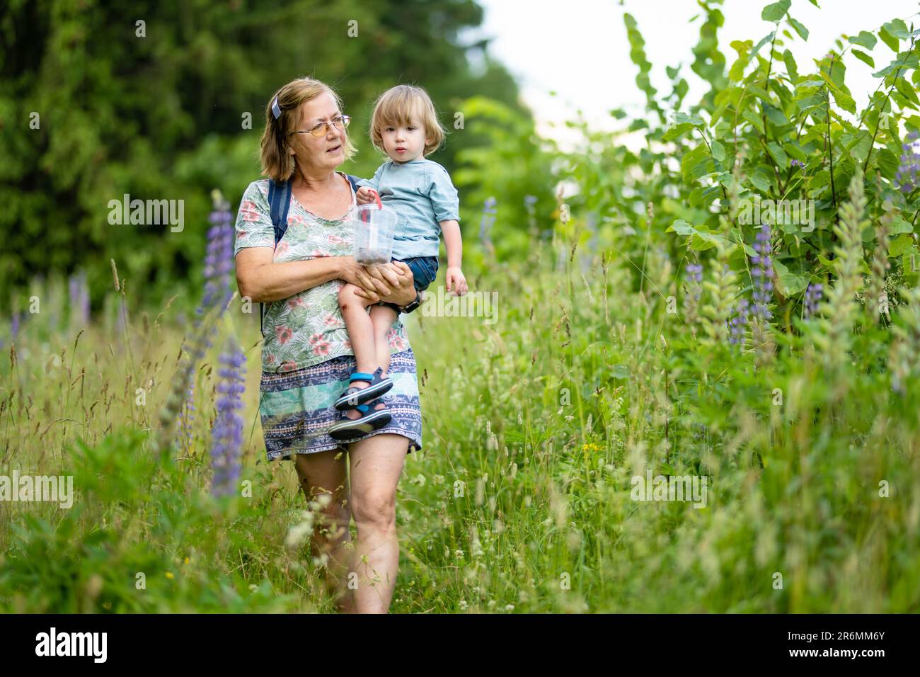 Grandmother with her toddler grandson having fun outdoors on beautiful ...