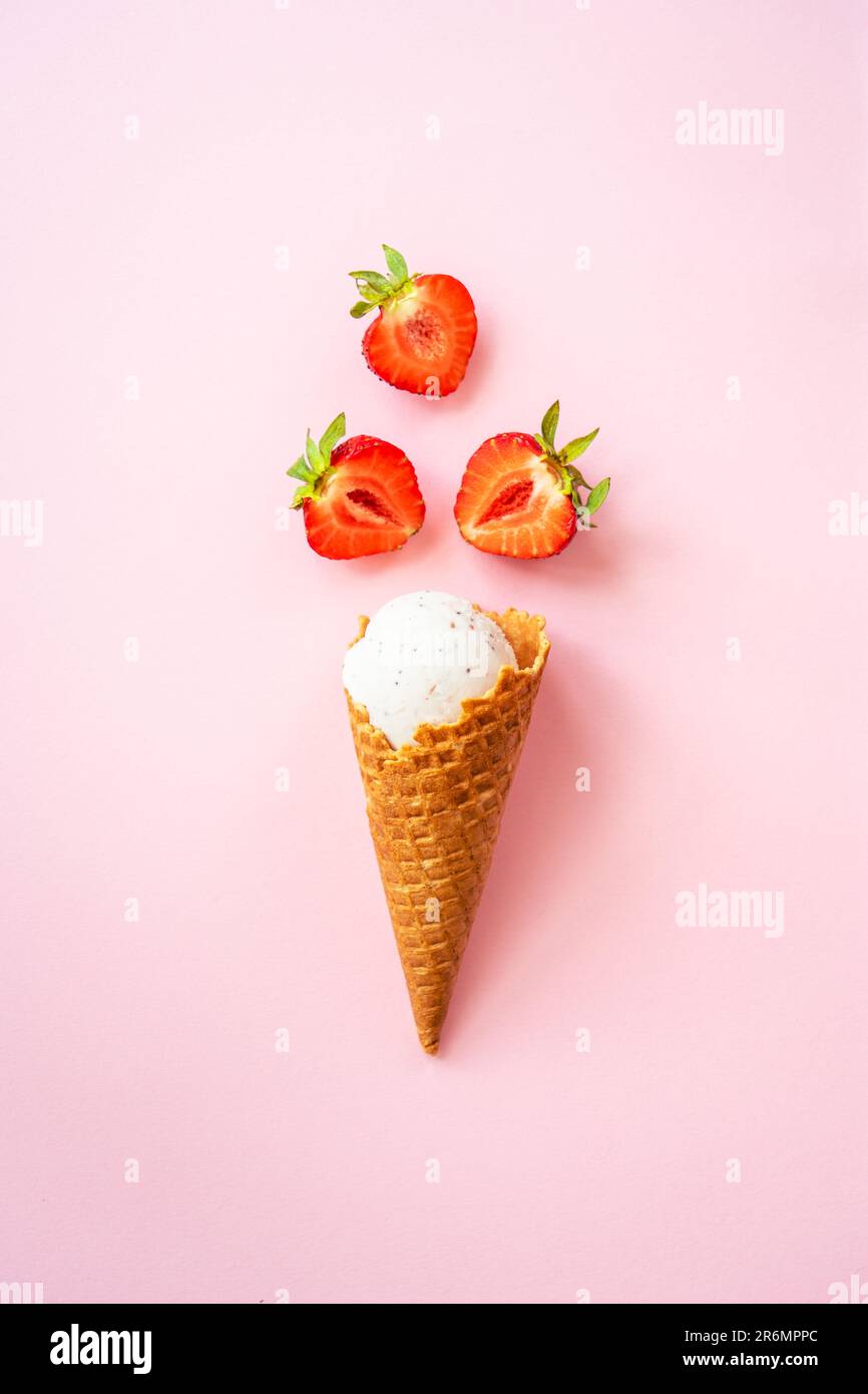 Strawberry ice cream cone top view on pink Stock Photo - Alamy