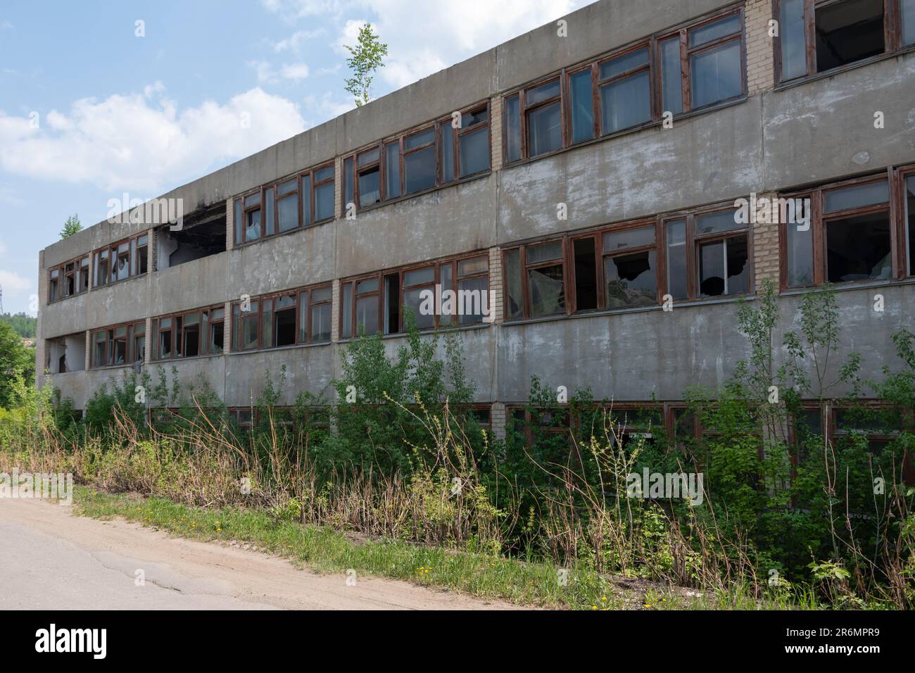 Broken windows in the facade of an old brick building. Broken glass, a ...