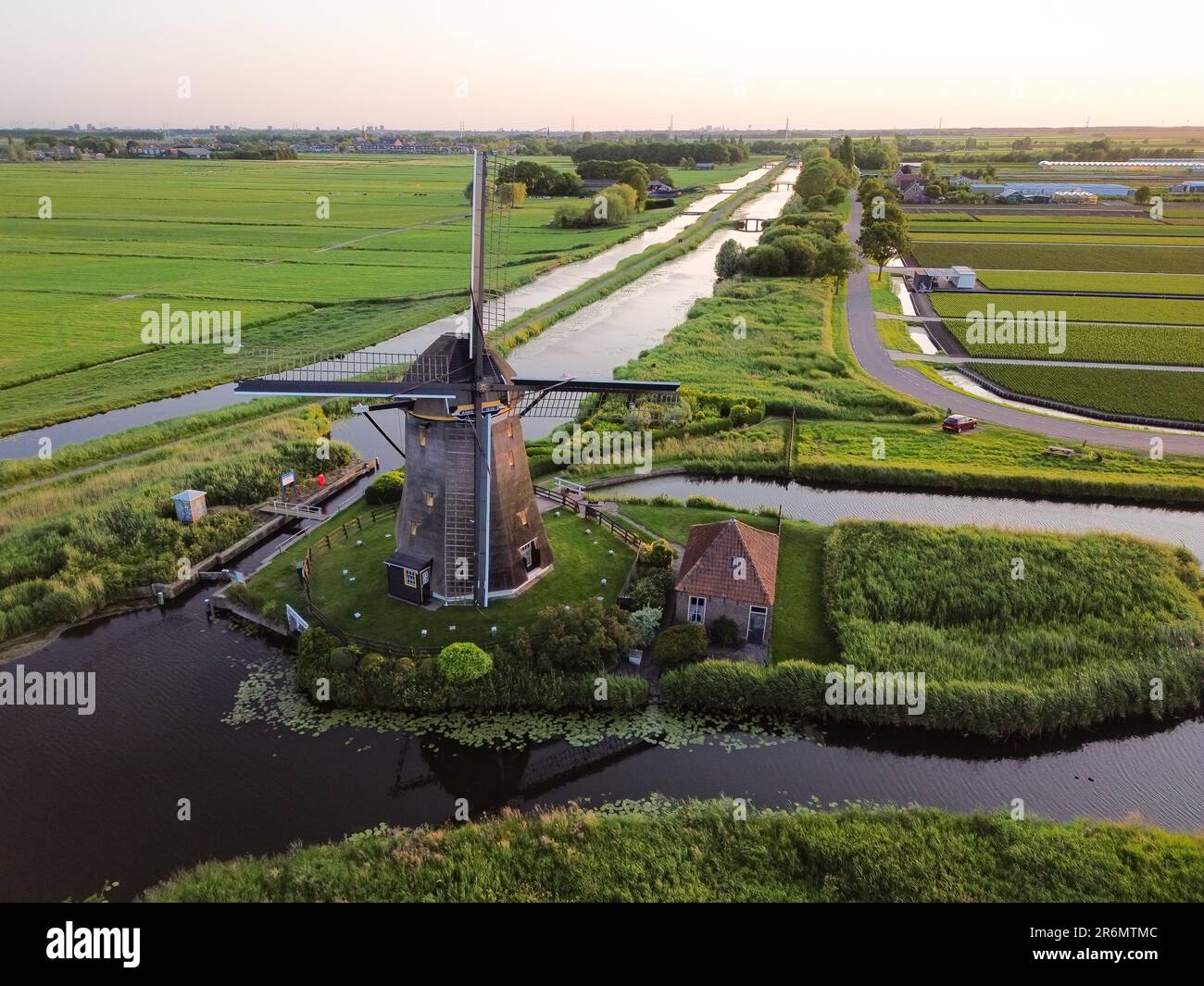 Aerial view of a classic Dutch windmill in the wide open landscape of ...