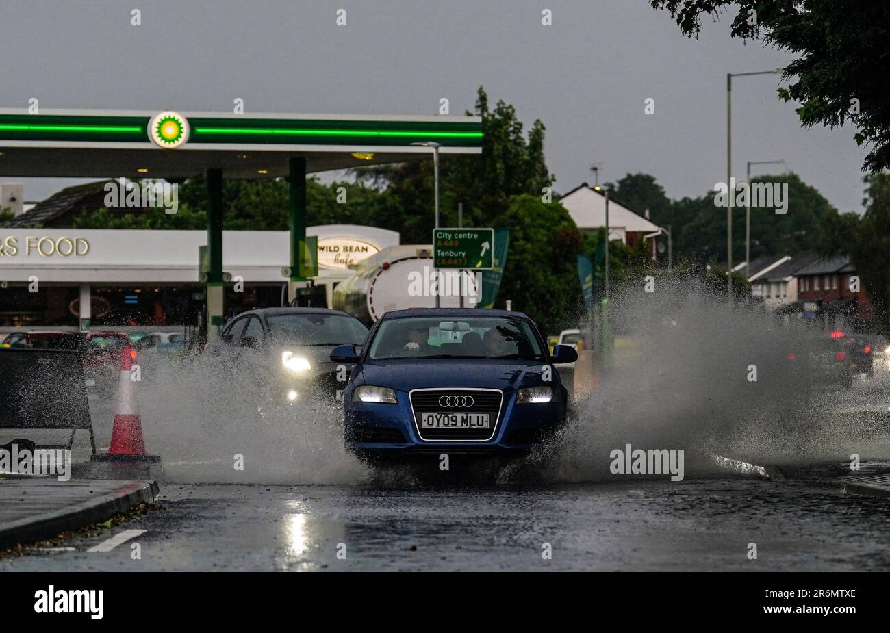 Vehicles are driven through flash flooding in the Lower Wick area of ...