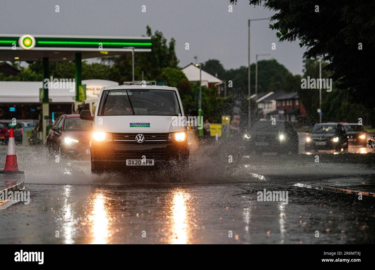 Vehicles are driven through flash flooding in the Lower Wick area of ...
