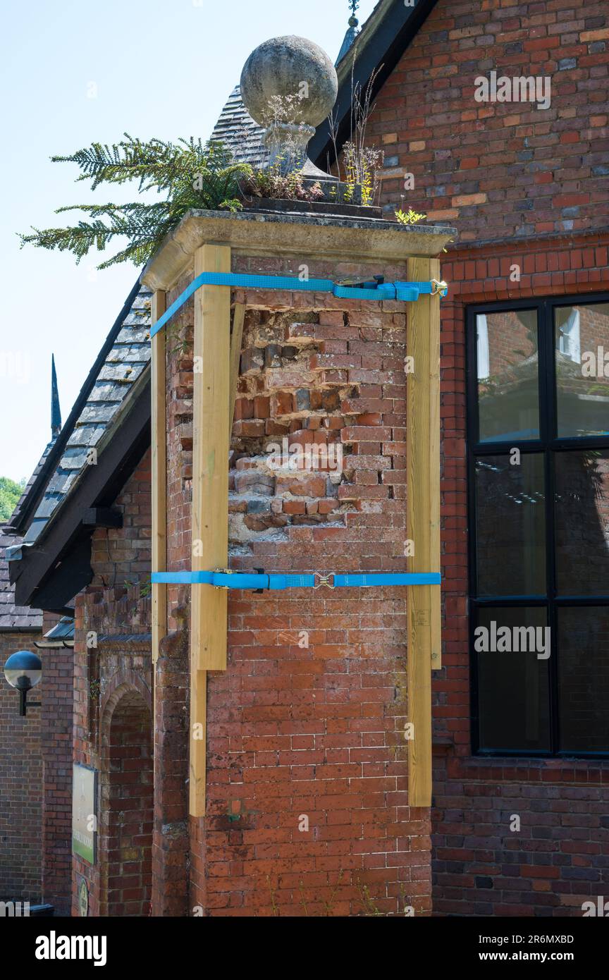 Temporary timber supports on crumbling brick column gate post Stock ...