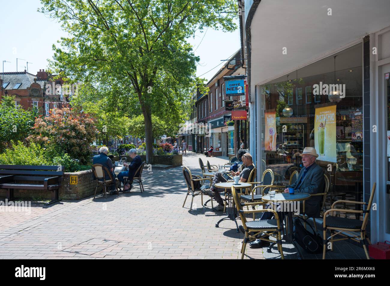 People seated at pavement tables enjoying refreshments outside Cafe ...