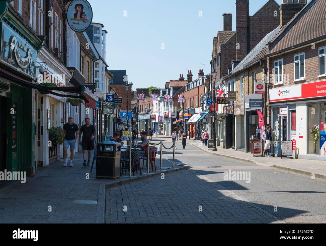 Rickmansworth High Street on a sunny summer day. People shopping. Two ...