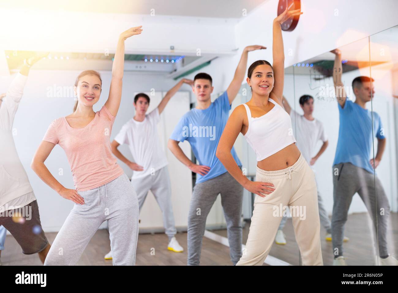 Group of happy young adult multinational sports people exercising ...