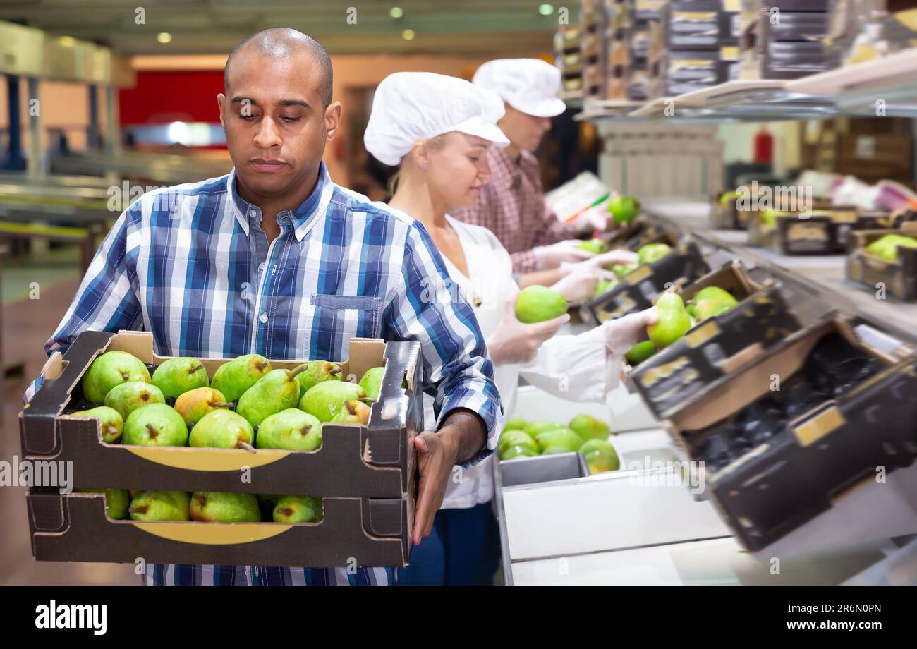 Man working at fruit warehouse, stacking boxes Stock Photo - Alamy