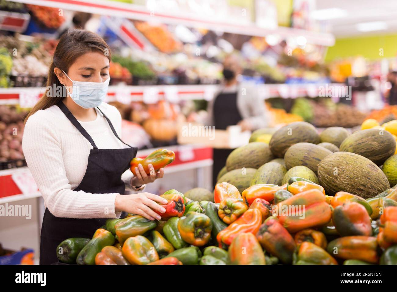 Latin supermarket workers in personal protective equipment during ...