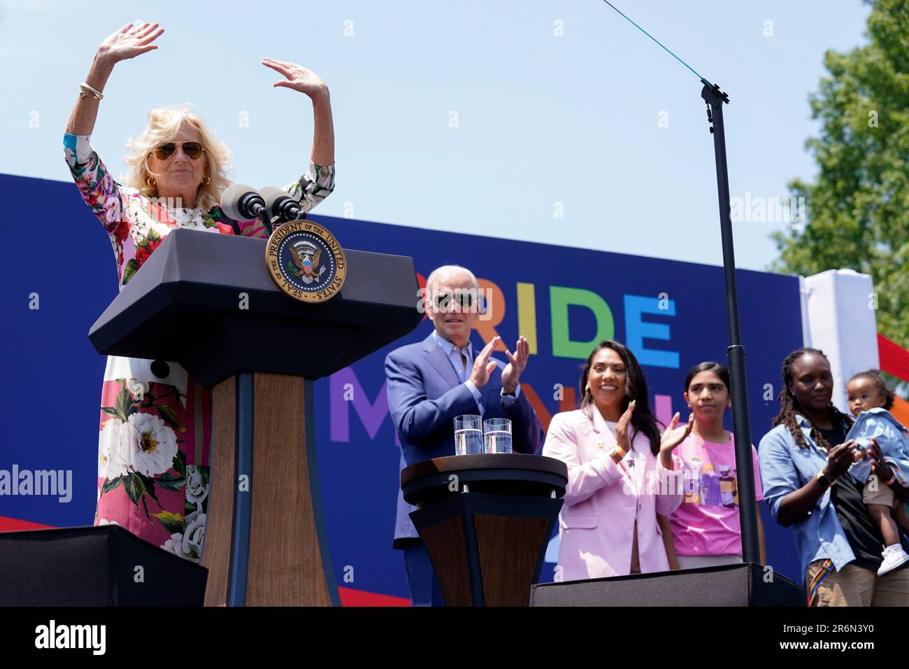 President Joe Biden applauds as first lady Jill Biden waves to the ...