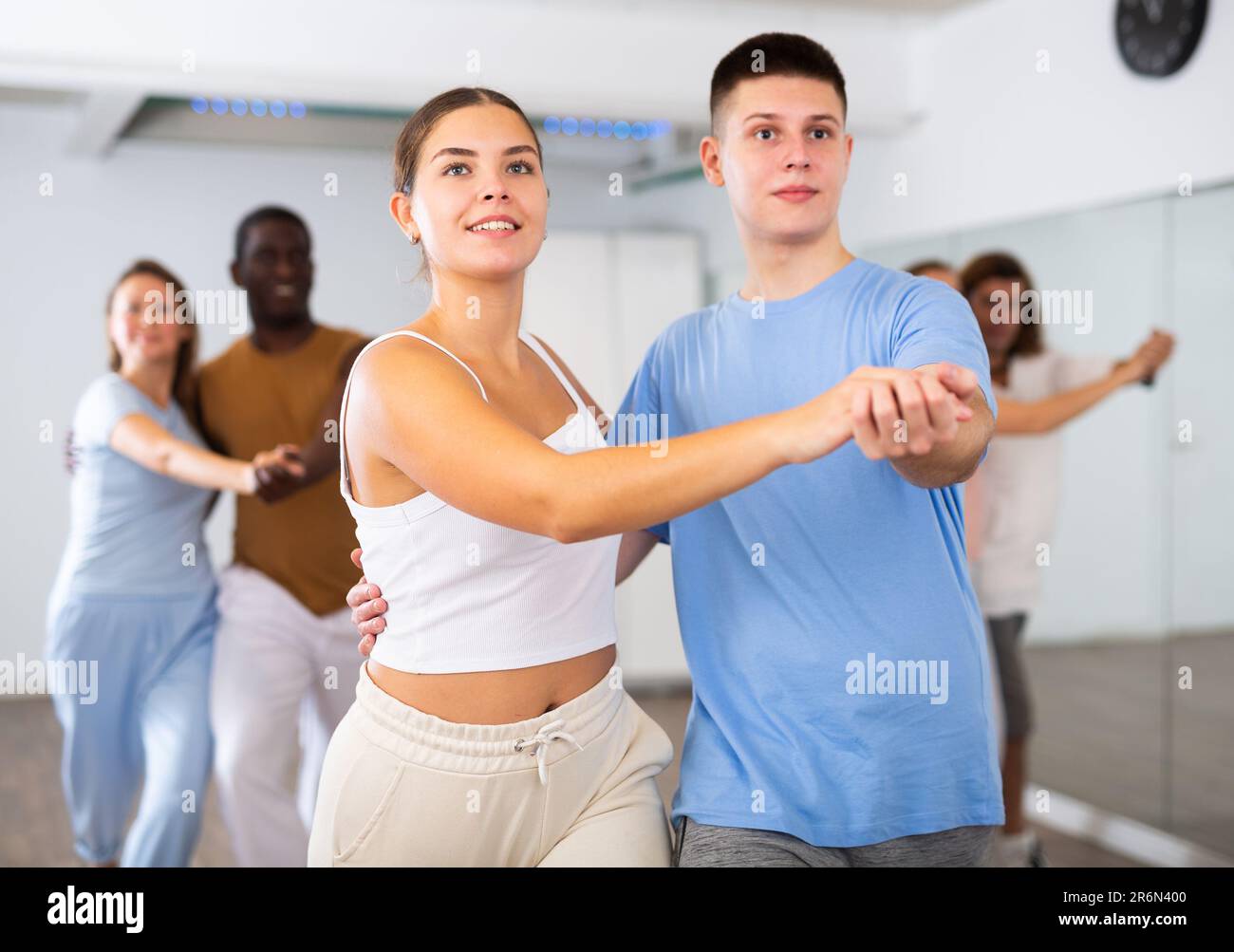 Young woman and teen boy dancing pair dance Stock Photo - Alamy