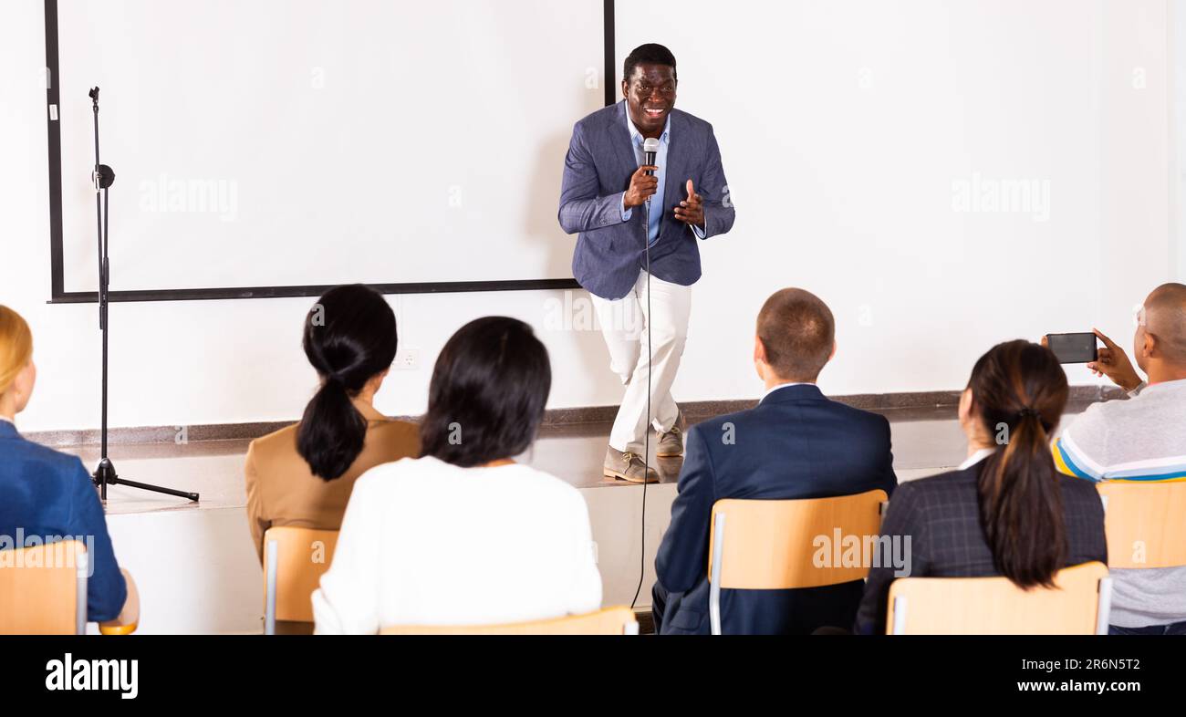 Young emotional male coach giving motivational speech Stock Photo - Alamy