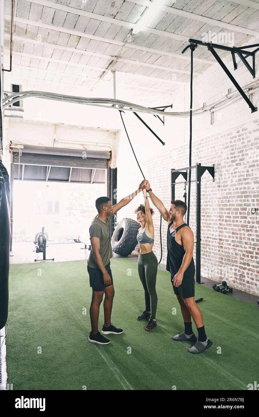Coming together for a full-body workout. three sporty young people ...