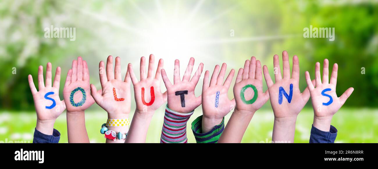 Children Hands Building Word Solutions, Grass Meadow Stock Photo - Alamy
