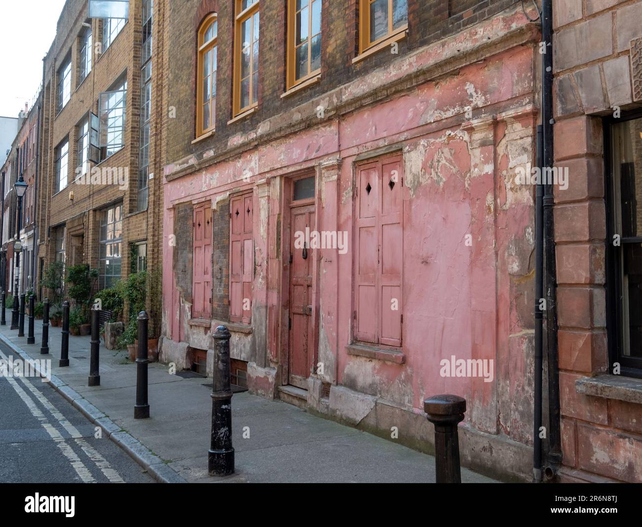 Exterior facade of shabby dilapidated red - pink painted traditional ...