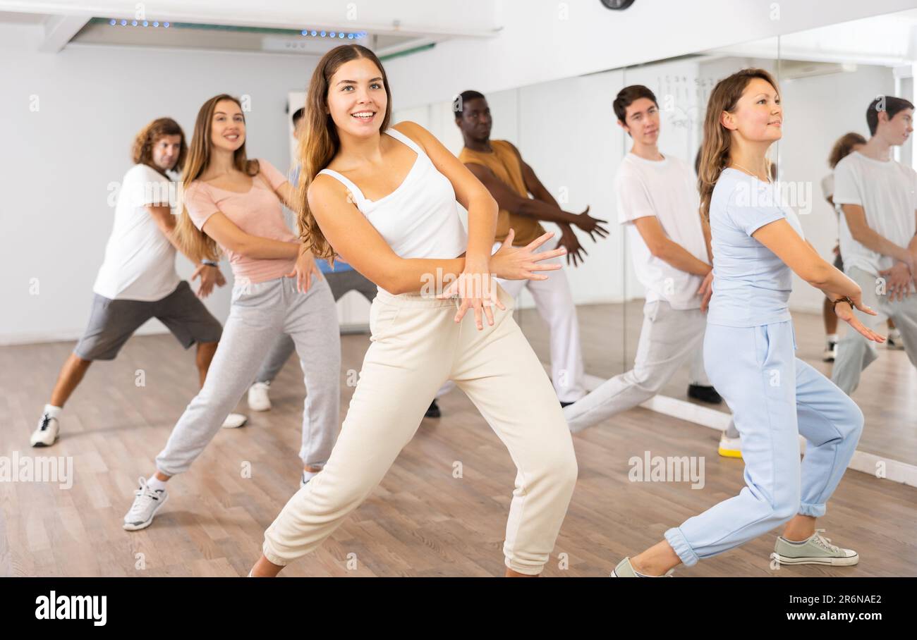 Group of international people dancing in gym with crossed hands. The ...
