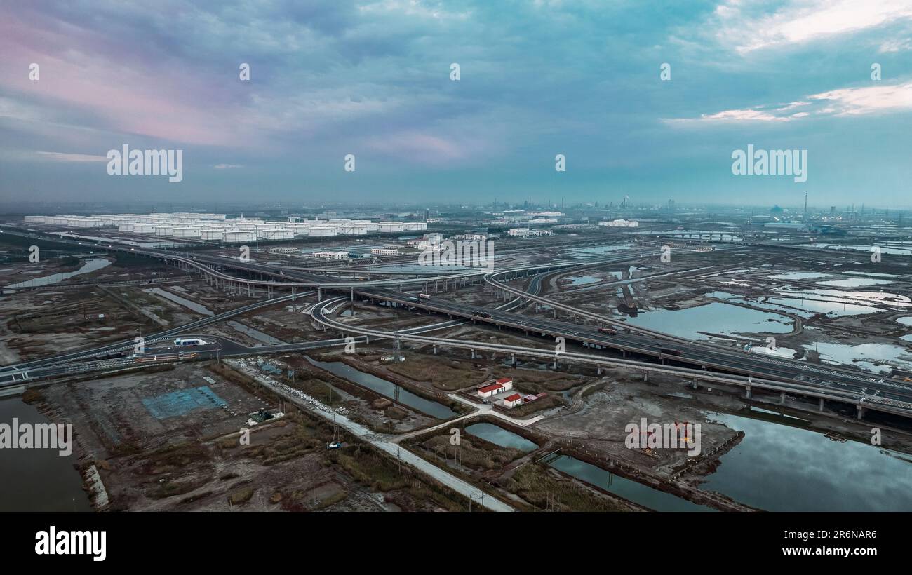 An aerial view of a cityscape featuring a bridge connecting two high ...