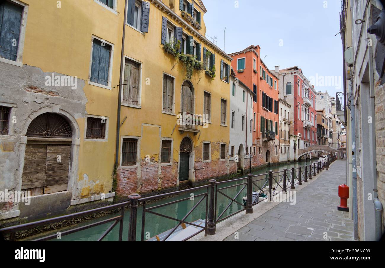Venice Canal View with Stone Walkway and Distant Bridge Stock Photo - Alamy