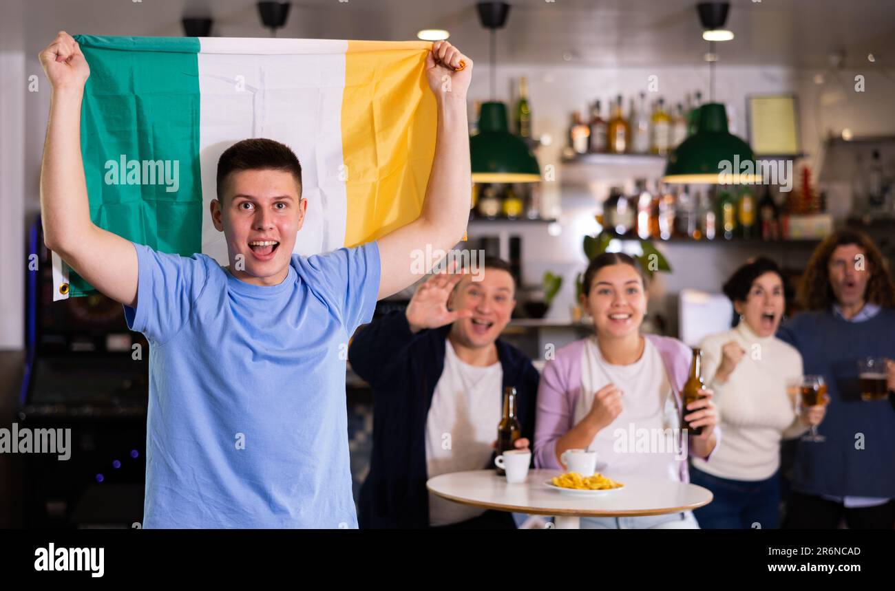 Group of excited fans friends rejoicing winning match game with Irish ...