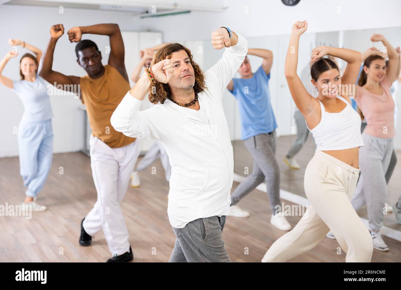 Group of different people rehearsing dance in dance studio Stock Photo ...